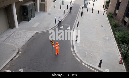 Banksman traffic marshall with fluorescent suit and helmet with stop ...