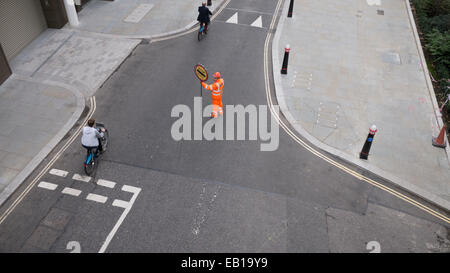 Banksman traffic marshall with fluorescent suit and helmet with stop ...