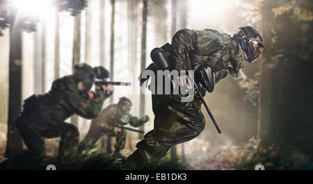 Paintball team in action rainy forest location Stock Photo - Alamy
