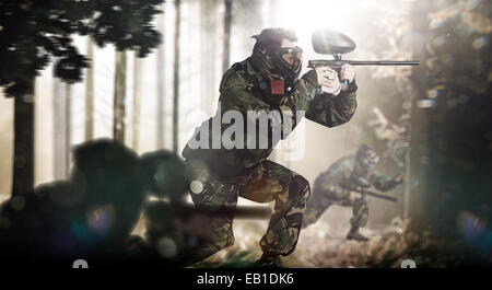 Paintball team in action rainy forest location Stock Photo - Alamy