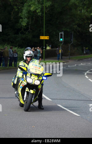 A Police motorcyclist performs a rolling road closure for the Tour of ...
