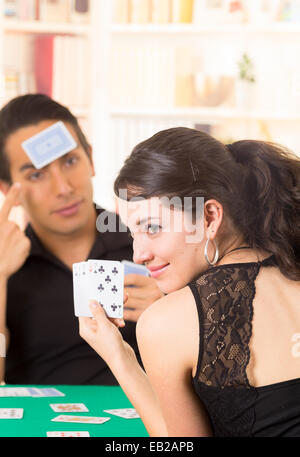 young couple playing cards cuarenta Stock Photo - Alamy