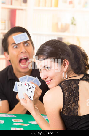 young couple playing cards cuarenta Stock Photo - Alamy