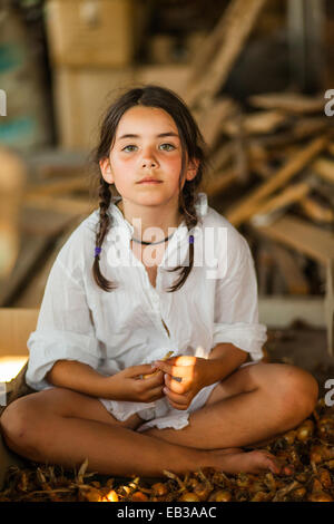 Girl sitting cross legged smiling Stock Photo - Alamy