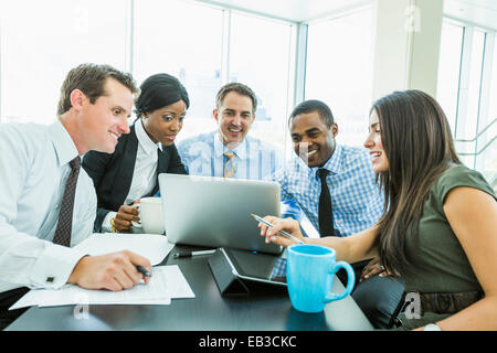 Business people using a laptop computer in their office Stock Photo - Alamy