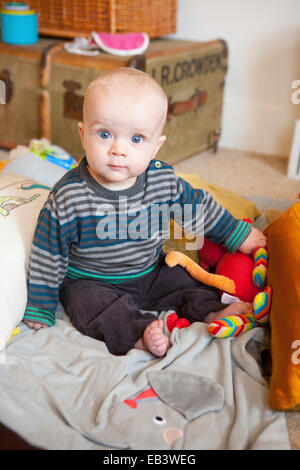 Baby boy playing with toys on the floor Stock Photo - Alamy