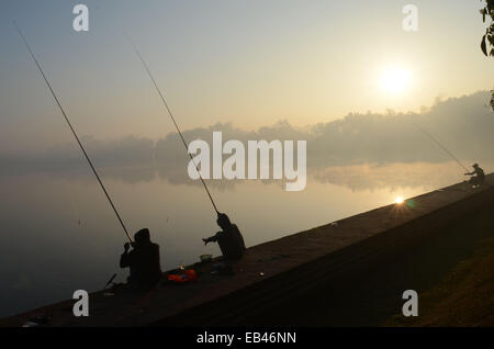Residents fishing at Segaran pool in the village of Trowulan. An area ...