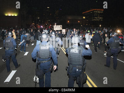 A Los Angeles Metro Police officer aims a less-lethal weapon during a ...
