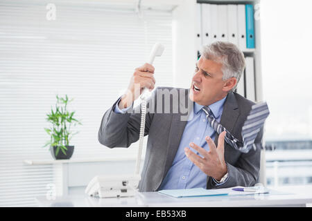 Angry businessman shouting on the phone Stock Photo - Alamy