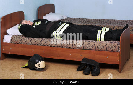 Firefighter sleeping dressed in Bunker gear on the bed Stock Photo - Alamy