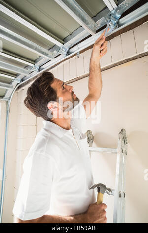 Construction worker fixing the ceiling Stock Photo - Alamy