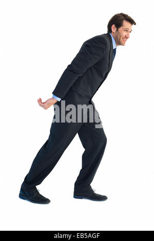 Business man pulling something isolated on white background Stock Photo ...