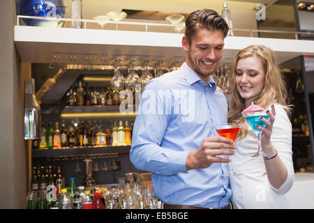 Young beautiful couple standing drinking cup of coffee at new home ...