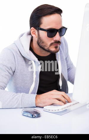 Man wearing sunglasses hacking into laptop Stock Photo - Alamy