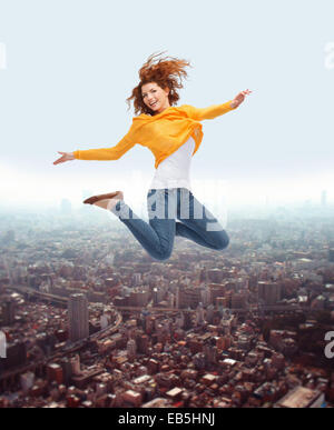 Young woman flying high in blue sky Stock Photo - Alamy