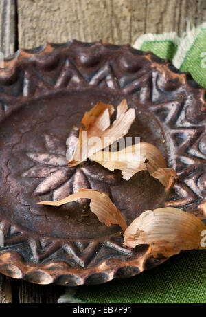 Onion peel or skin on wood background Stock Photo - Alamy