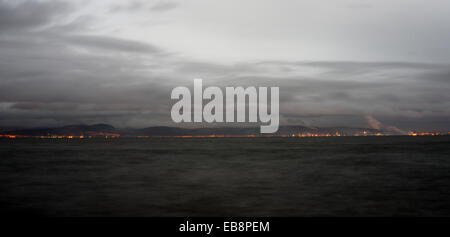 A view towards Swansea from Port Talbot, South Wales during sunset on ...