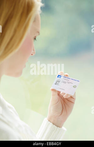 Woman holding driving license Stock Photo - Alamy