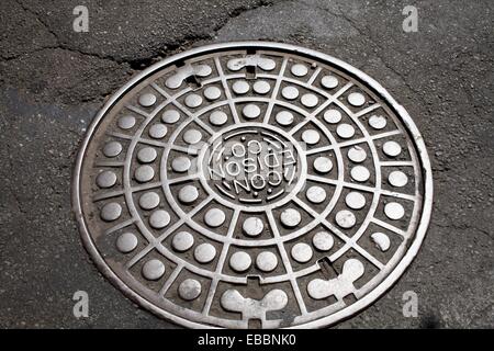 Gas manhole cover in pavement, UK Stock Photo - Alamy