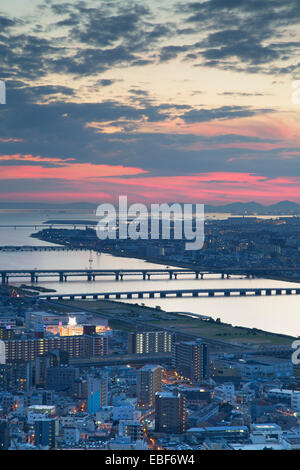 Elevated Osaka city view at sunset over Yodo river and railway bridges ...
