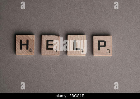 Simple collection of scrabble letters to spell out the word help. I ...