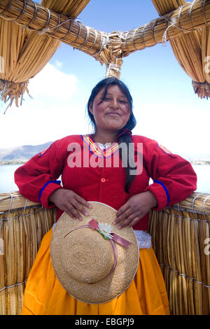 Uro woman standing up on Totora reed and watching to the lake. The Uru ...