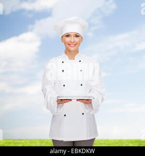 smiling female chef with tablet pc computer Stock Photo - Alamy