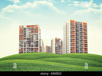 high-rise buildings over green hills, air balloons above Stock Photo ...