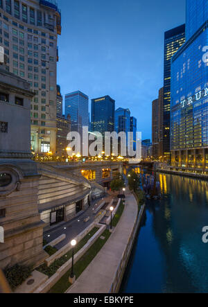 Chicago River Walk with urban skyscrapers and bridge illuminated with ...