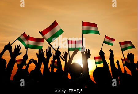 Silhouettes of People Holding the Flag of Hungary Stock Photo - Alamy