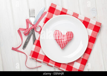 Valentines day heart shaped toy gift and silverware. View from above ...
