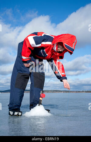 Winter fishing. Fishing rod stands on the ice. Fishing theme Stock ...