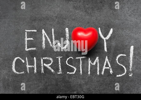 enjoy Christmas exclamation handwritten on chalkboard with heart symbol ...