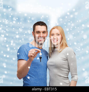 Young hispanic man holding keys of new home celebrating achievement ...