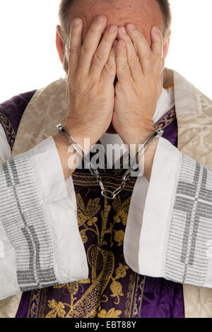 Catholic church symbols and handcuffs. Church and crime Stock Photo - Alamy