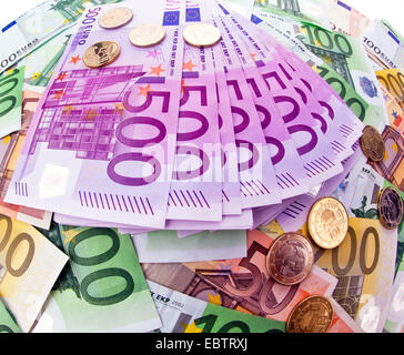 many 100 euro bills and coins with a colorful chart Stock Photo - Alamy