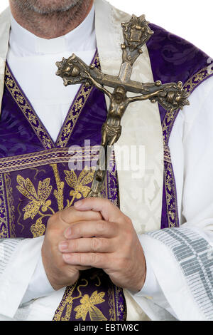 Catholic priest holding Holy Cross and Bible performing exorcisms shot ...