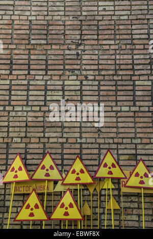 Yellow radiation warning signs in the wilderness near the Pripyat town ...