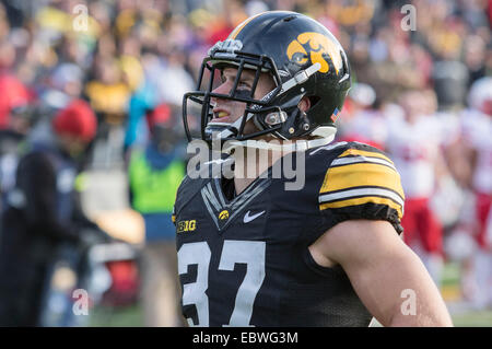 Iowa defensive back John Lowdermilk (37) holds onto the legs of ...