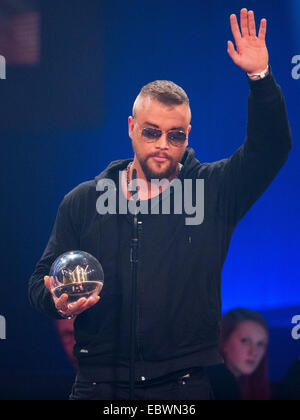Bochum, Germany. 4th Dec, 2014. Rapper Kollegah celebrates his award ...