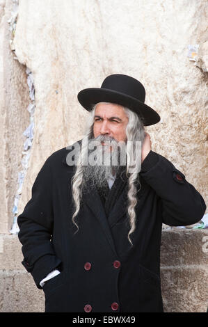 Praying bearded Jewish man with sidelocks in white kippah raising his ...
