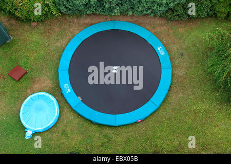 trampoline and paddling pool in garden Stock Photo - Alamy