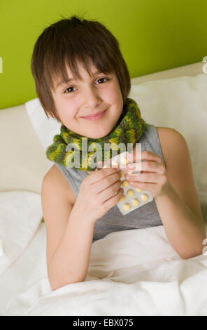 Sick boy taking tablets Stock Photo - Alamy
