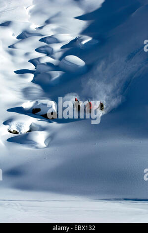 A woman skiing deep powder snow in a storm Alpine Meadows in Lake Tahoe ...