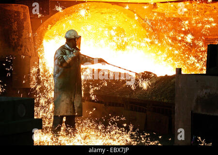 Man working at blast furnace iron tap hole Stock Photo - Alamy