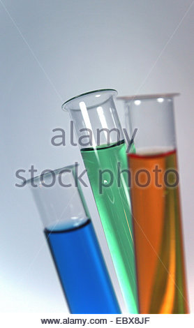 Three glass test tubes in stand, two containing oil and water, and one ...