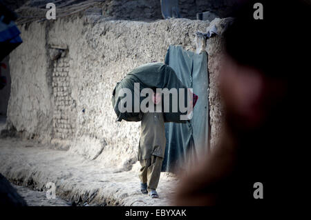 Kabul, Afghanistan. 2nd Dec, 2014. An Afghan man takes rest next to his ...