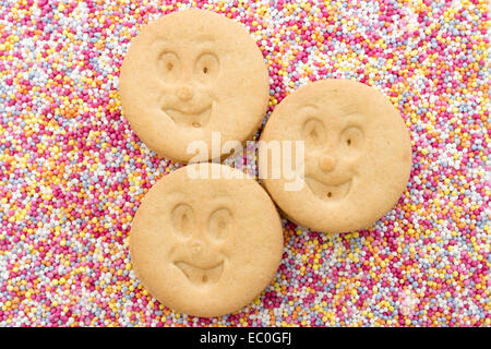 a background of colorful candy with smile biscuits Stock Photo - Alamy