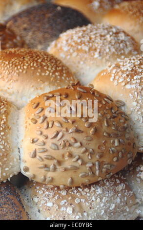 Rustic, freshly baked seeded bread rolls displayed for sale, UK Stock ...