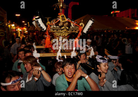 Festival participants carry "Omikoshi" - a portable Shinto shrine which ...